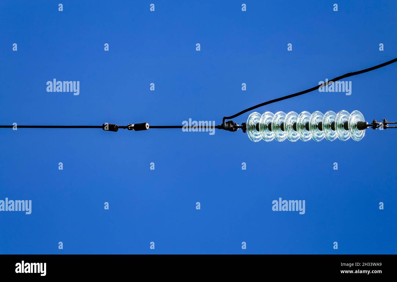 Close up of a transparent turquoise high voltage insulator or isolator ...