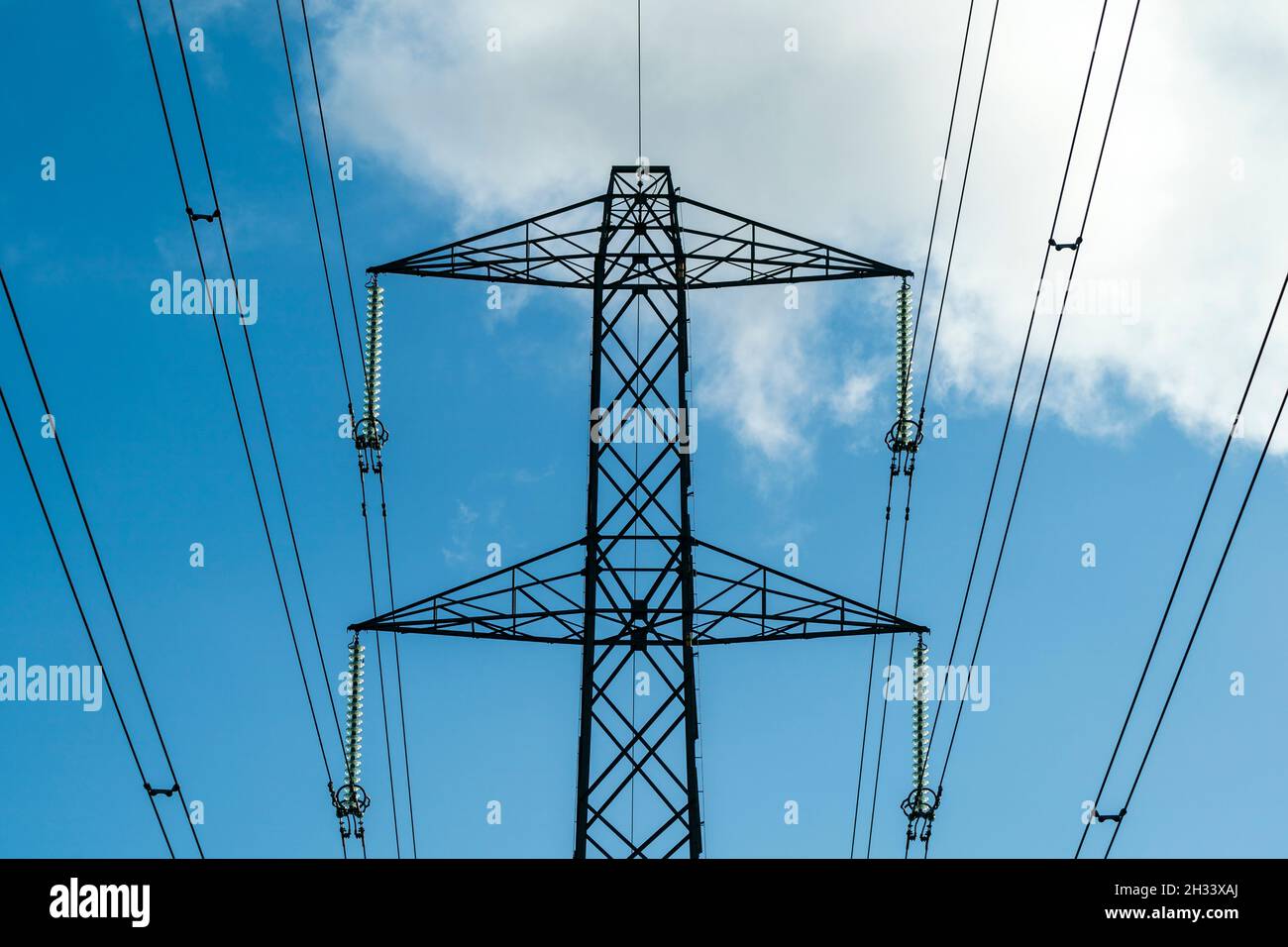 Top part of a pylon of the united Kingdom National Grid with overhead ...
