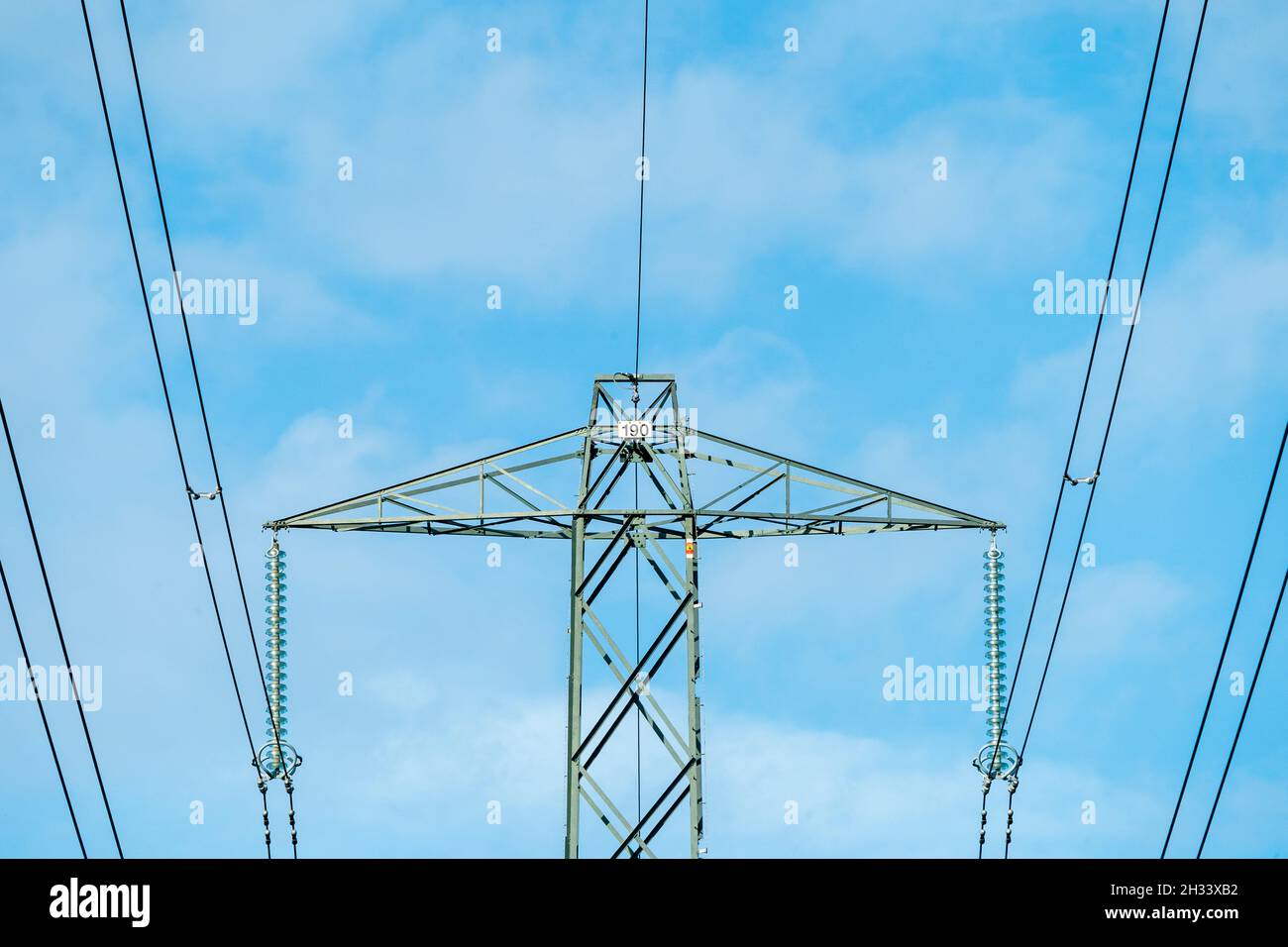 Top part of a pylon of the united Kingdom National Grid with overhead ...