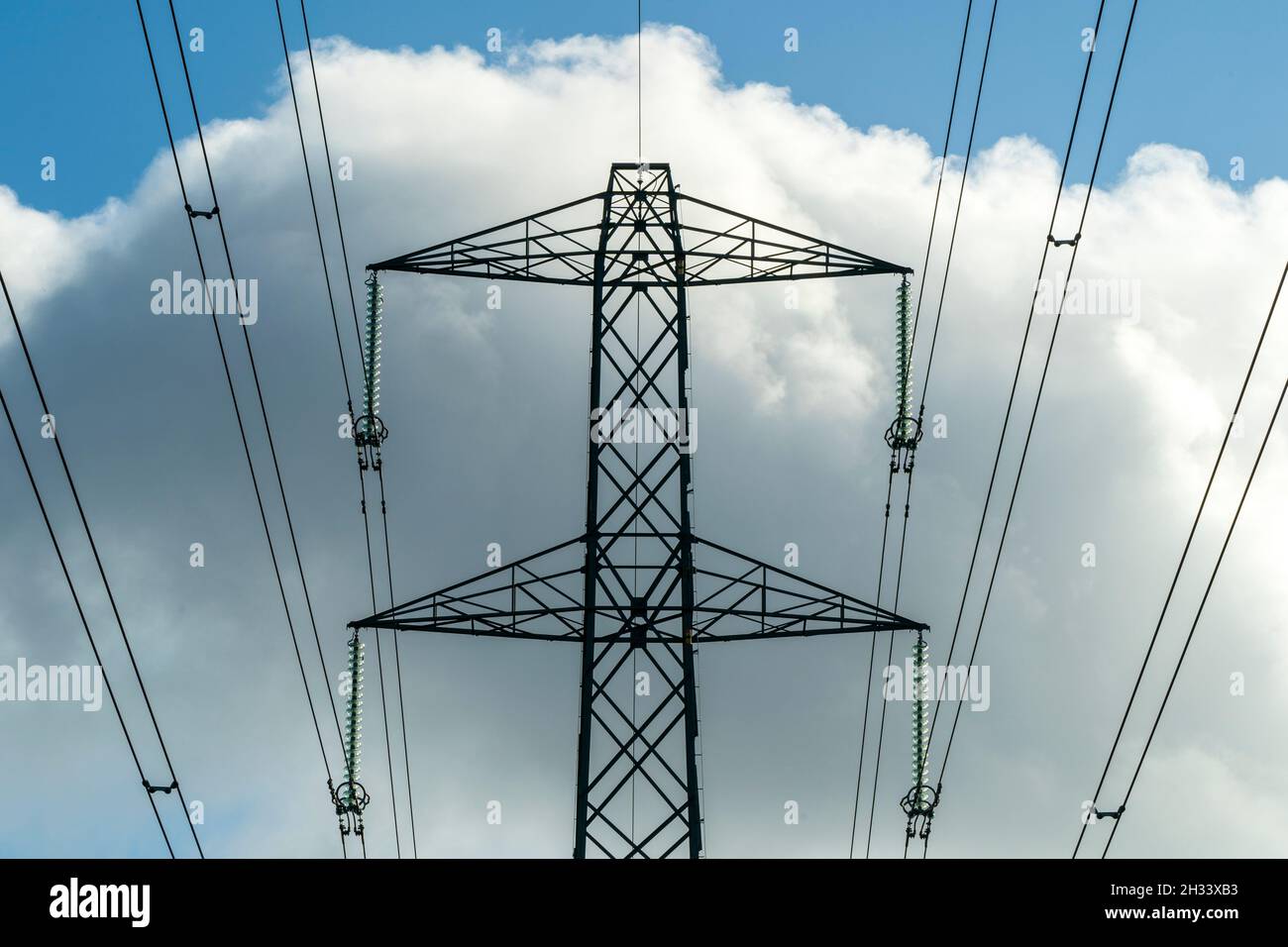 Top part of a pylon of the united Kingdom National Grid with overhead ...