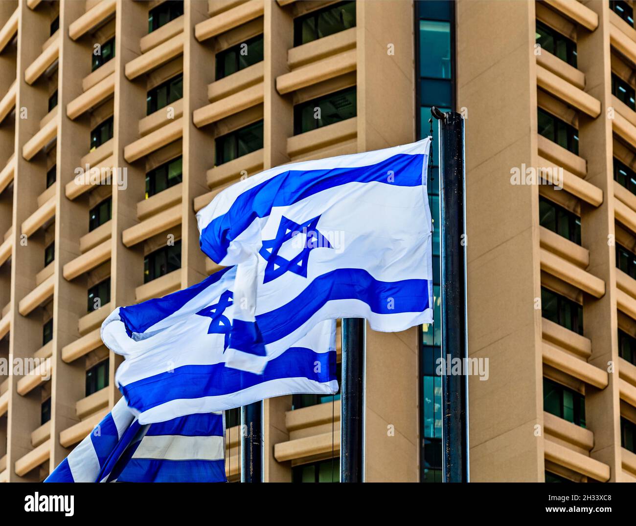 Israel flags on background of building in Tel Aviv Magen David sign ...