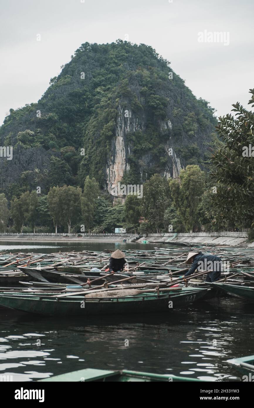 Vietnamese boats in the river with beautiful rocks in the background ...