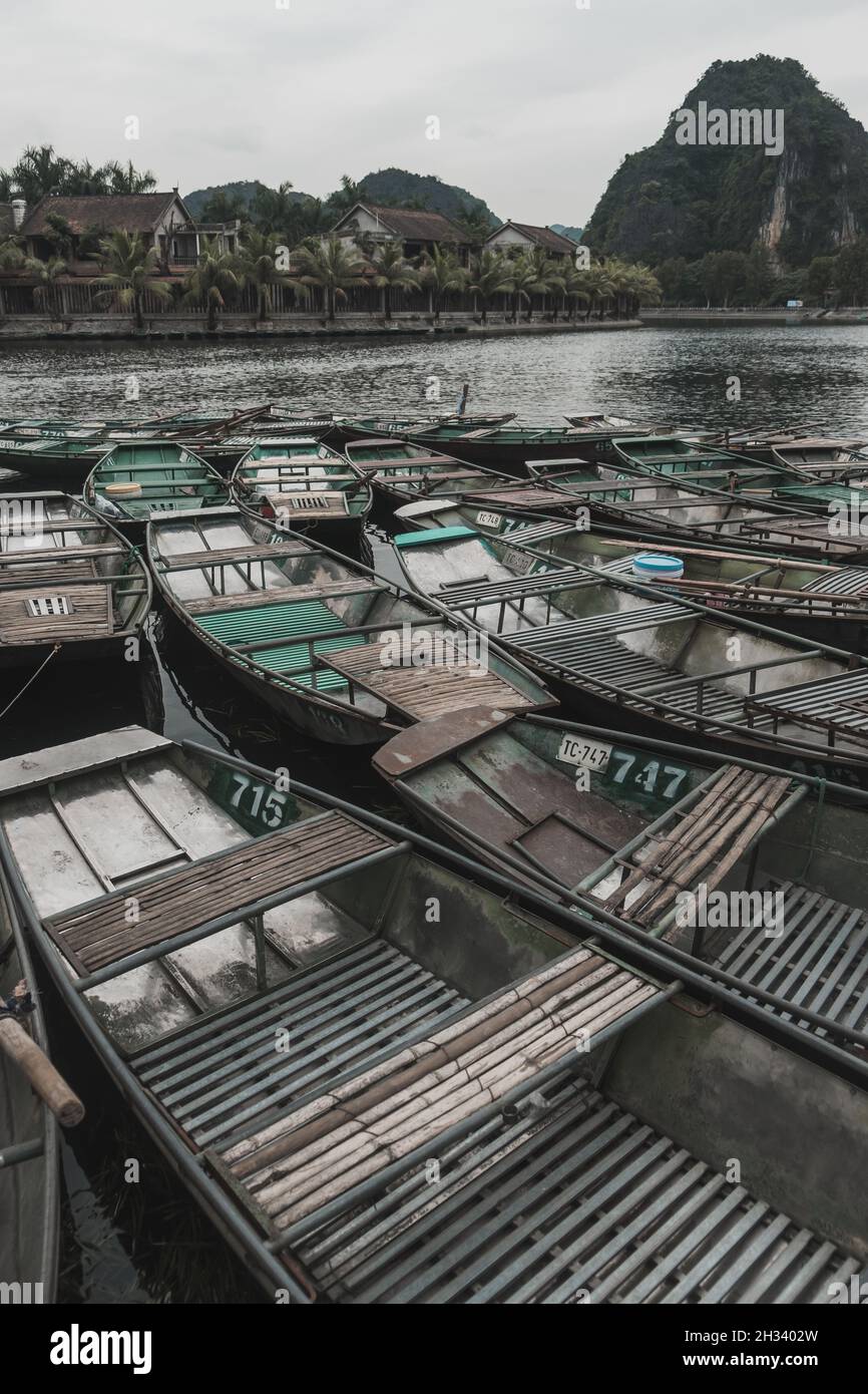 Vietnamese boats in the river with beautiful rocks in the background ...