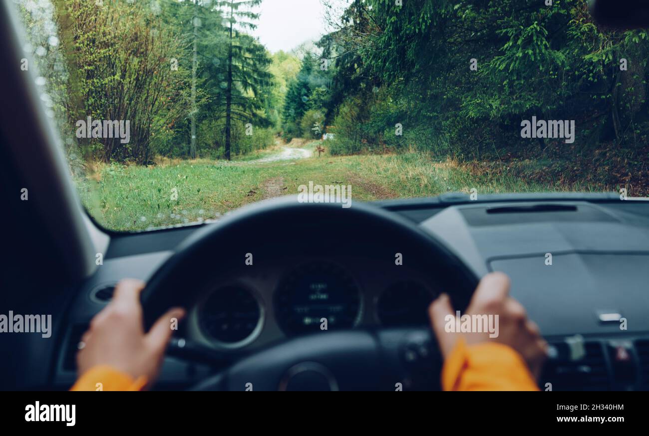Driver dressed bright orange jacket driving a modern off road left hand ...