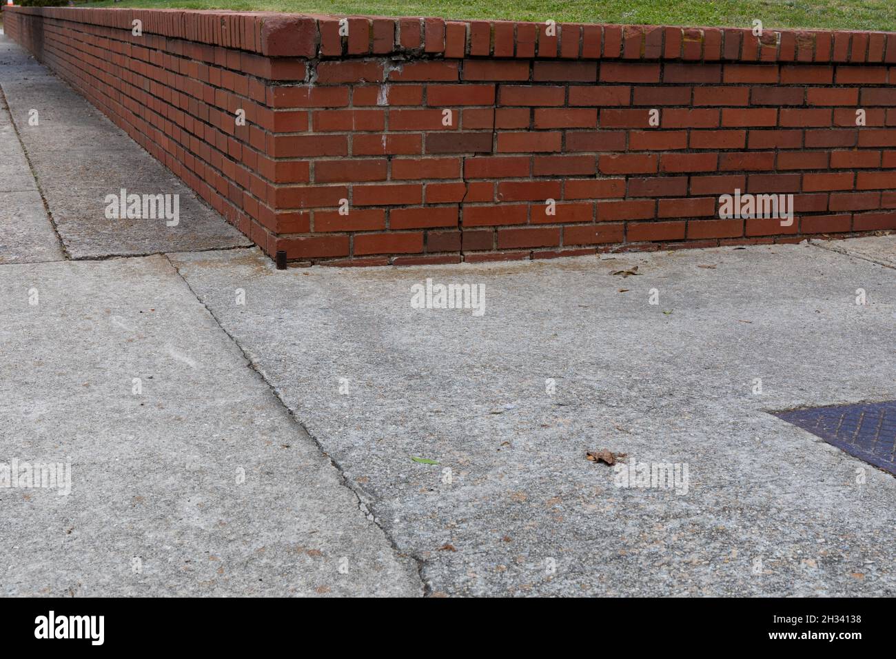 Very low view of a red brick retaining wall at the intersection of two ...