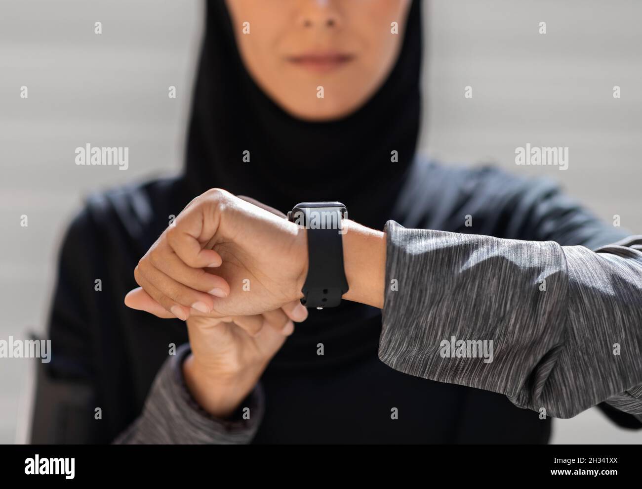 Sport Gadgets Concept. Unrecognizable Muslim Woman In Hijab Checking ...