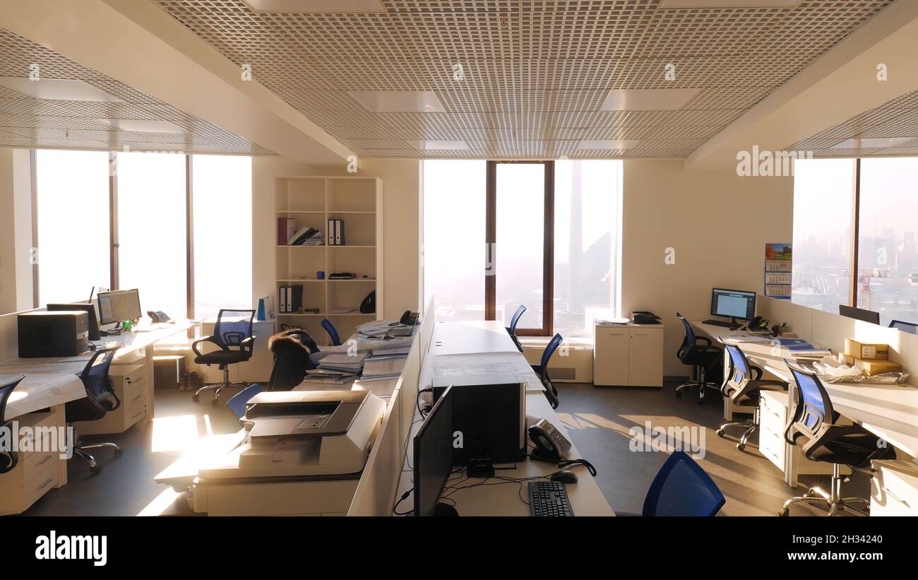 View of business office with one employee sitting at work alone. View ...