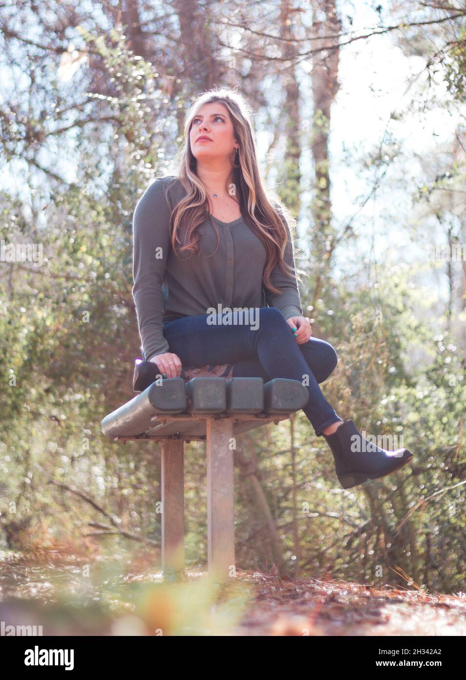 Stylish female model posing in the woods enjoying the fall or autumn ...