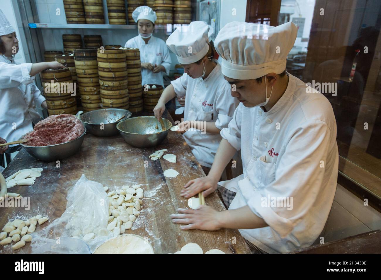 Cooks Making Dumplings In The Nanxiang Steamed Bun Restaurant In Old