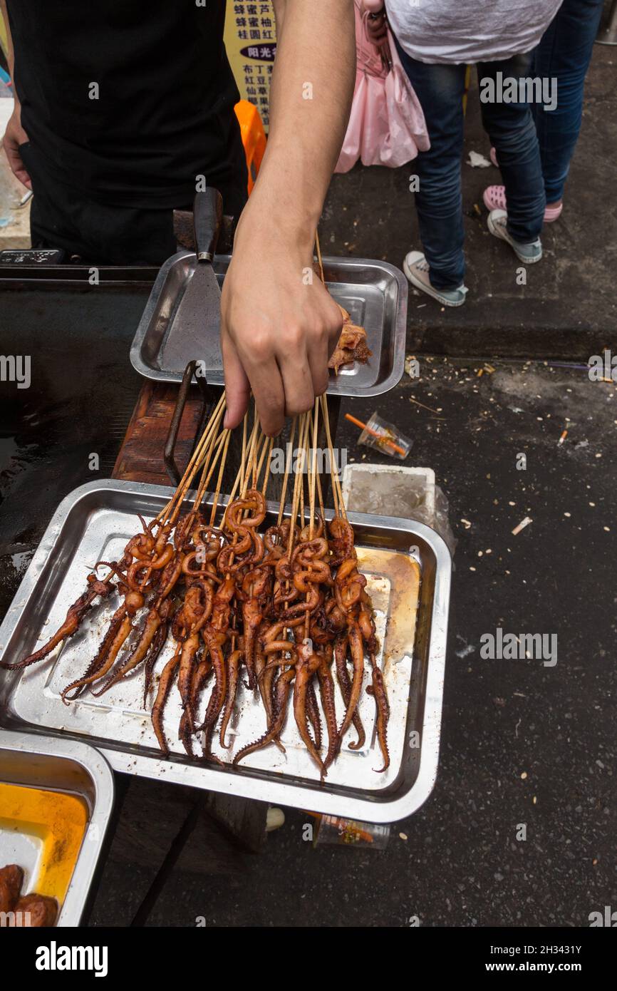 Skewers of octopus tentacles for sale on the street in Old Town ...
