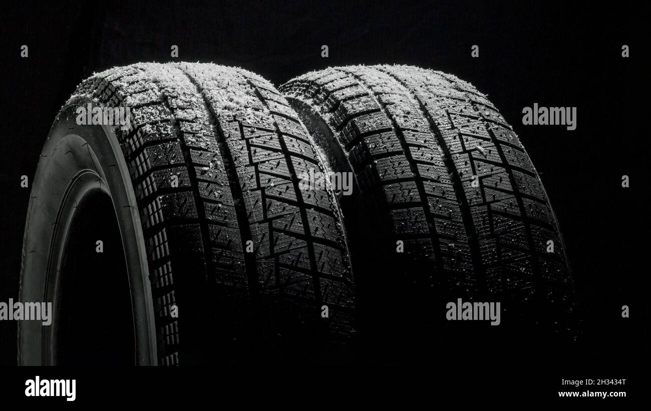 Winter Car tires with snow close-up wheel profile structure on black ...