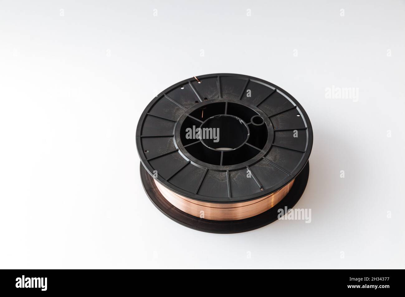 Welding wire spool on a white background Stock Photo - Alamy