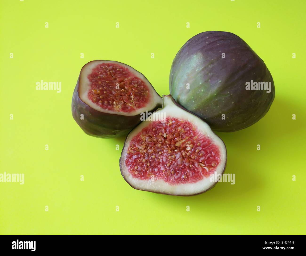 Ripe fresh sweet figs on bright yellow background Stock Photo - Alamy