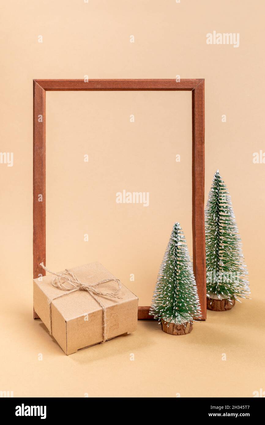 Festive minimal composition with empty wooden frame and wooden festive ...