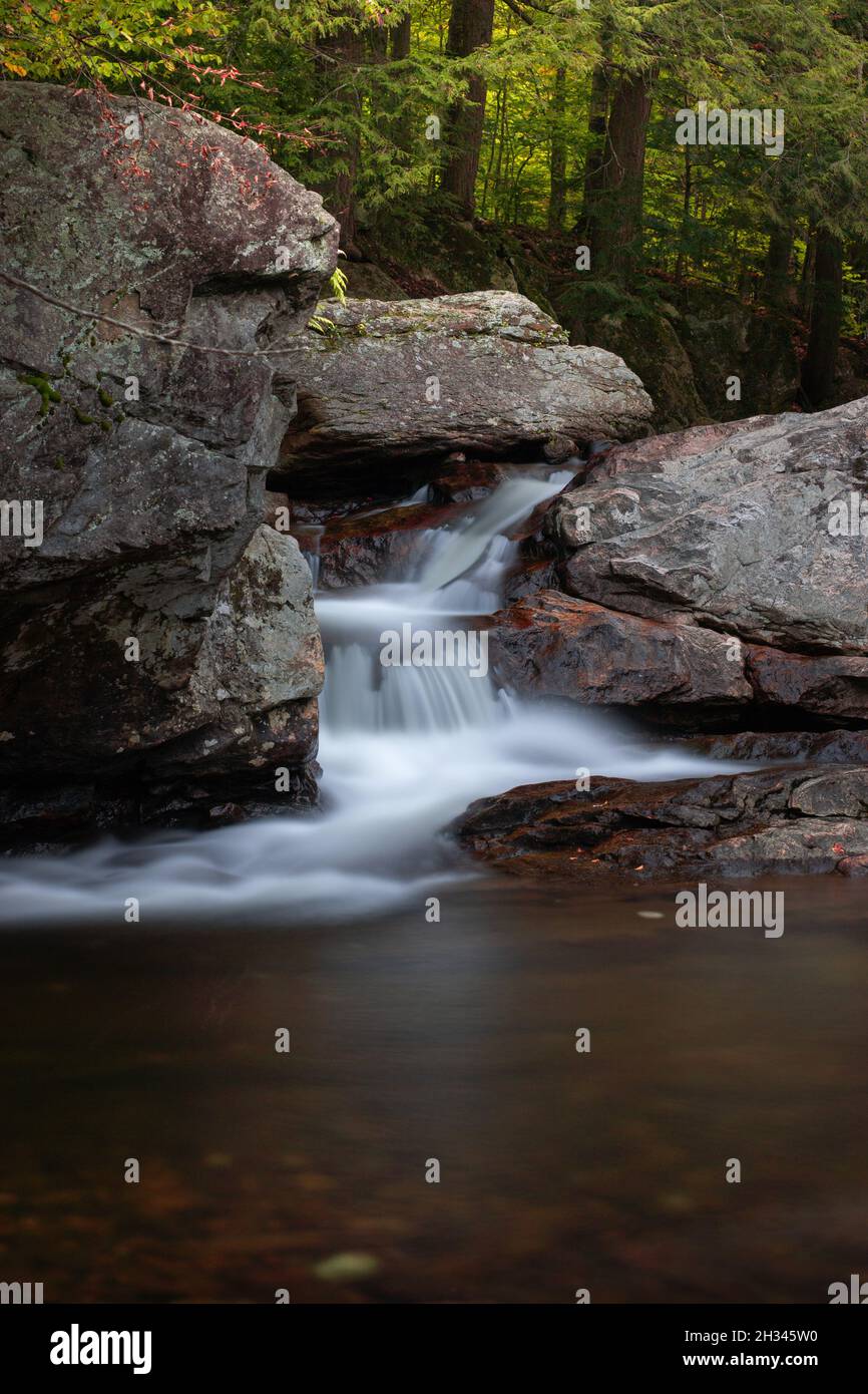 Vertical shot of river flowing over the rocks Stock Photo - Alamy