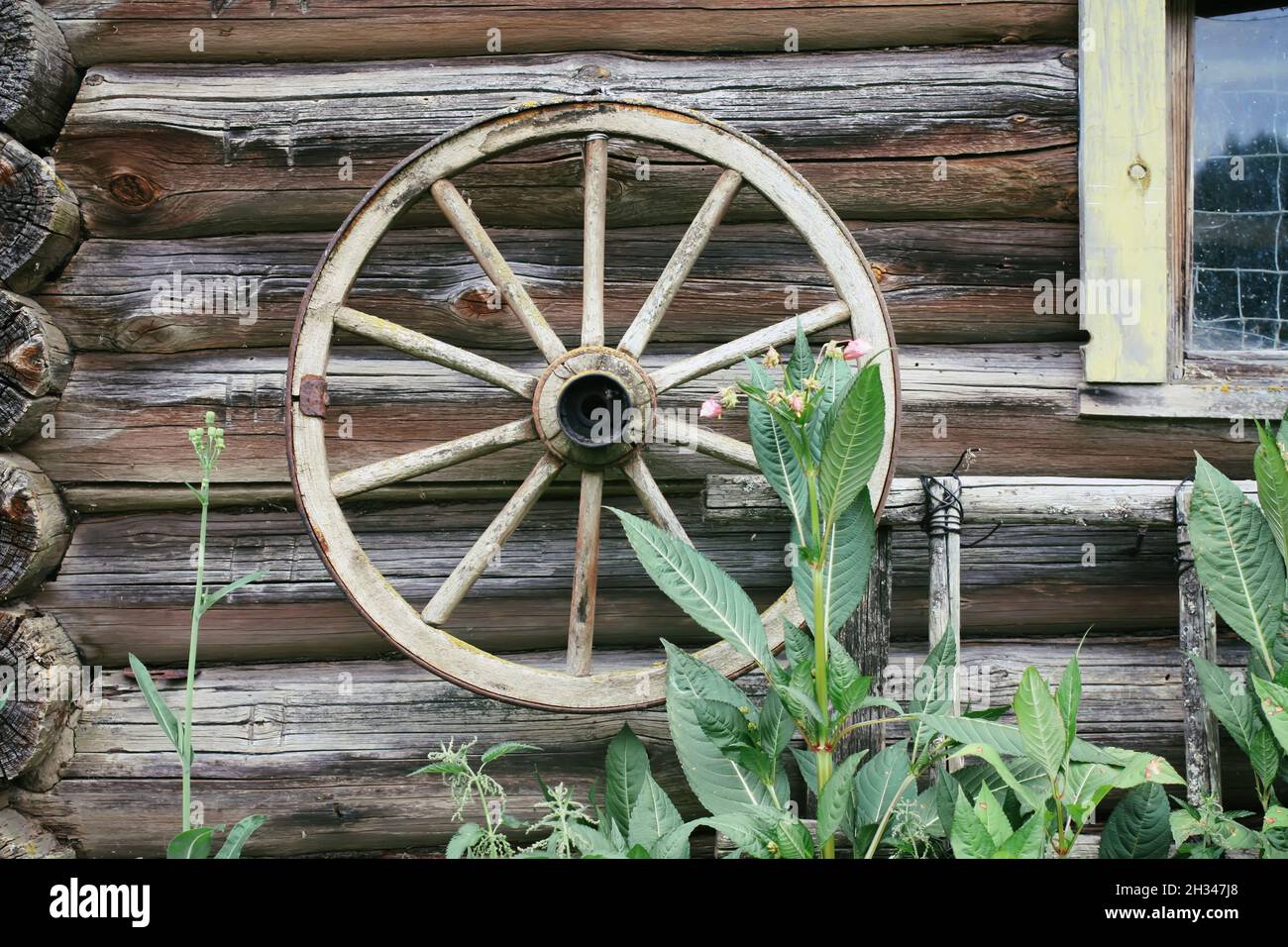 Weathered wall of old barn with wood coach wheel Stock Photo - Alamy