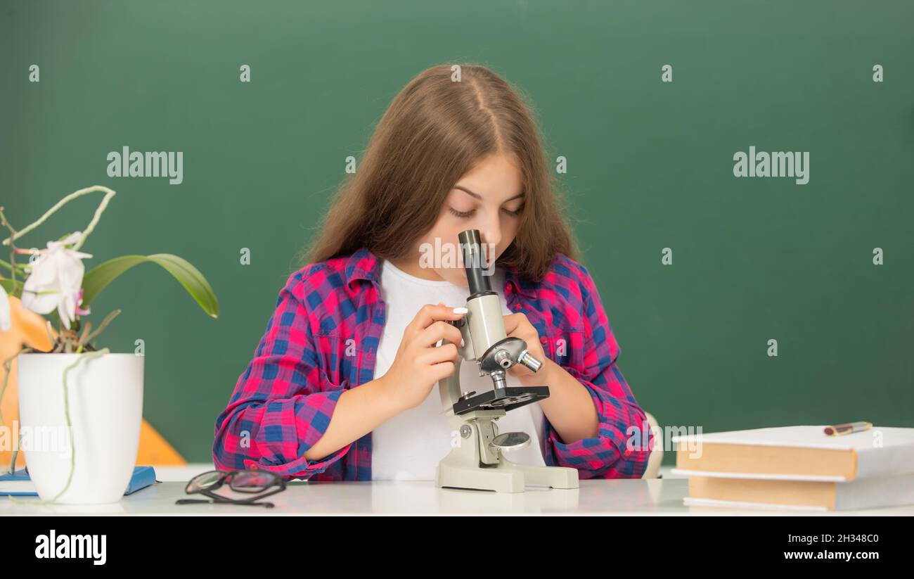 kid with microscope in classroom at blackboard, science Stock Photo - Alamy