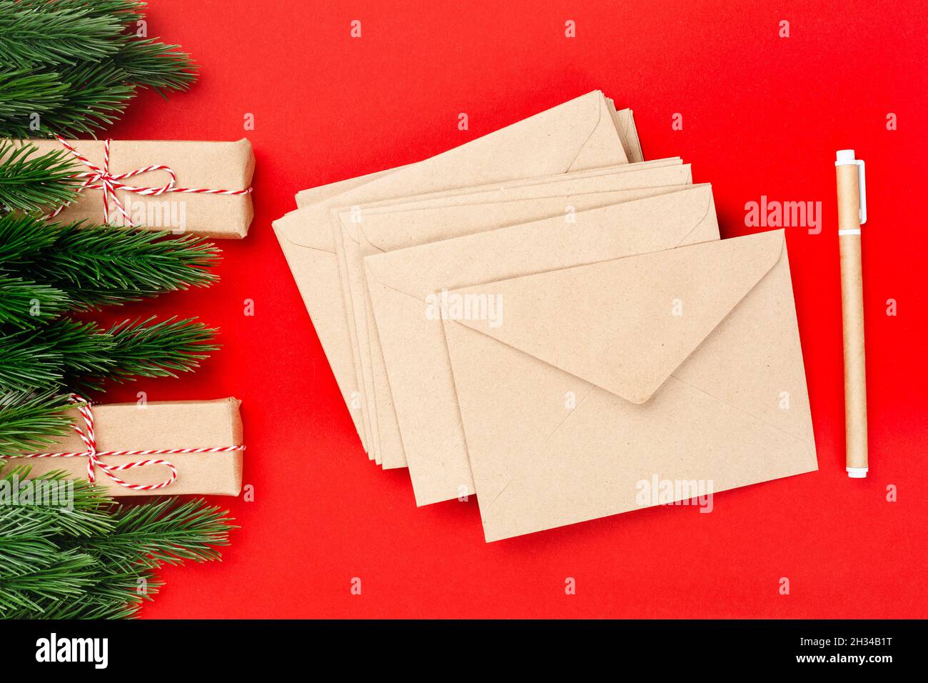 mockup blank stacks of paper craft envelopes and craft pen on red ...