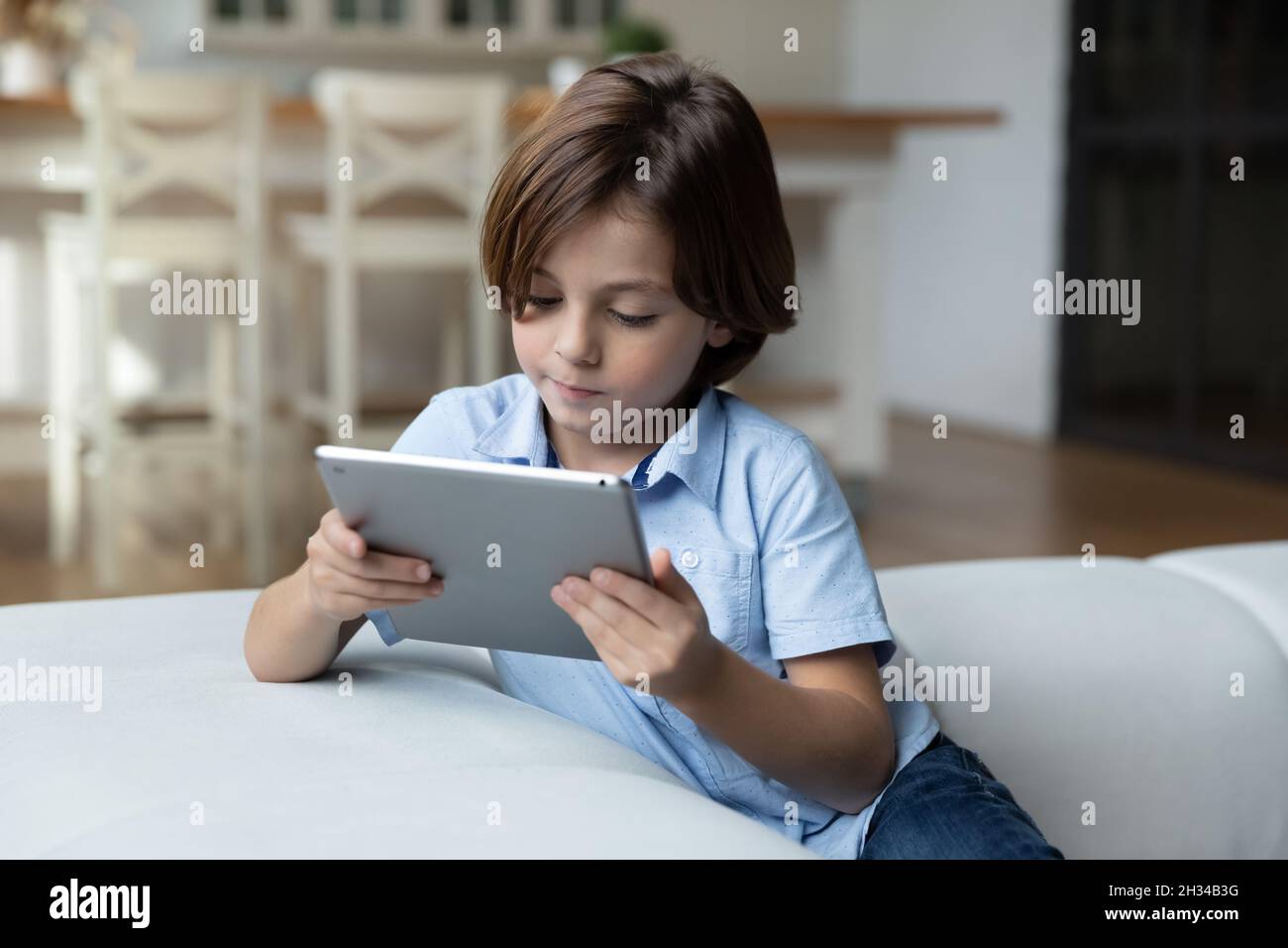 Concentrated serious gen Z school kid playing video game Stock Photo ...