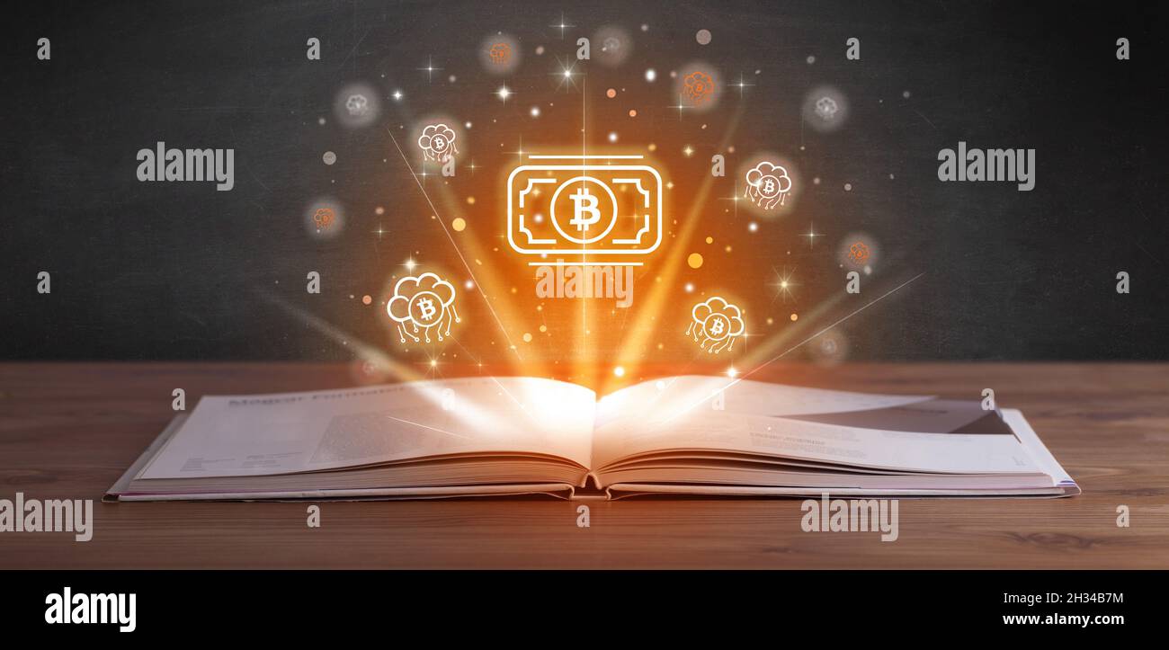 Open book with currency icons above Stock Photo - Alamy