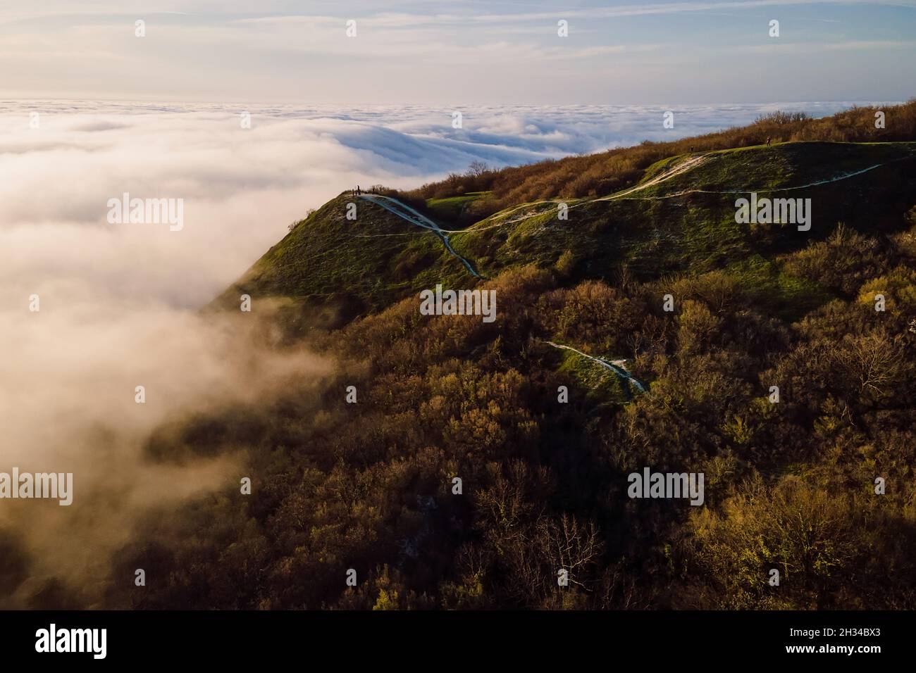 Aerial view with creeping clouds and mountains. Foggy weather Stock ...