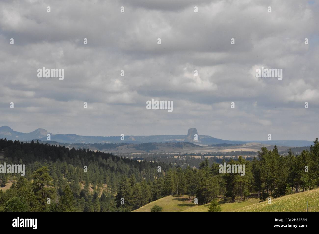 Thick gray clouds hovering over Devil's Tower in Wyoming Stock Photo ...