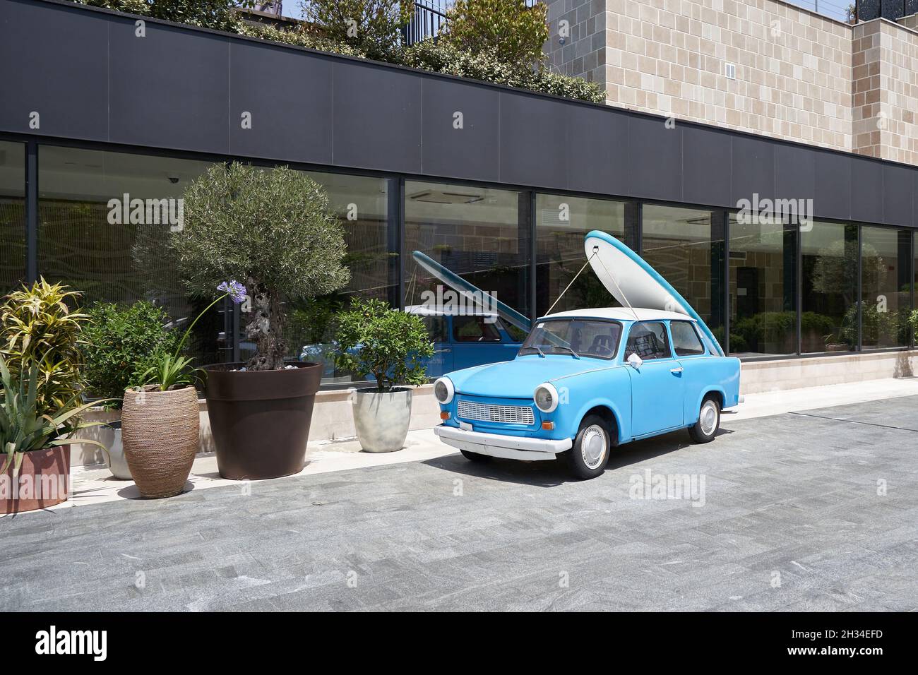 Blue retro car for decoration at the facade of a modern building Stock ...