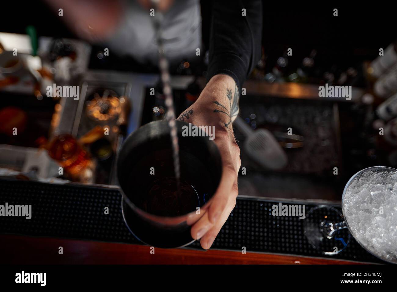 Barman stirring ice cubes hi-res stock photography and images - Alamy