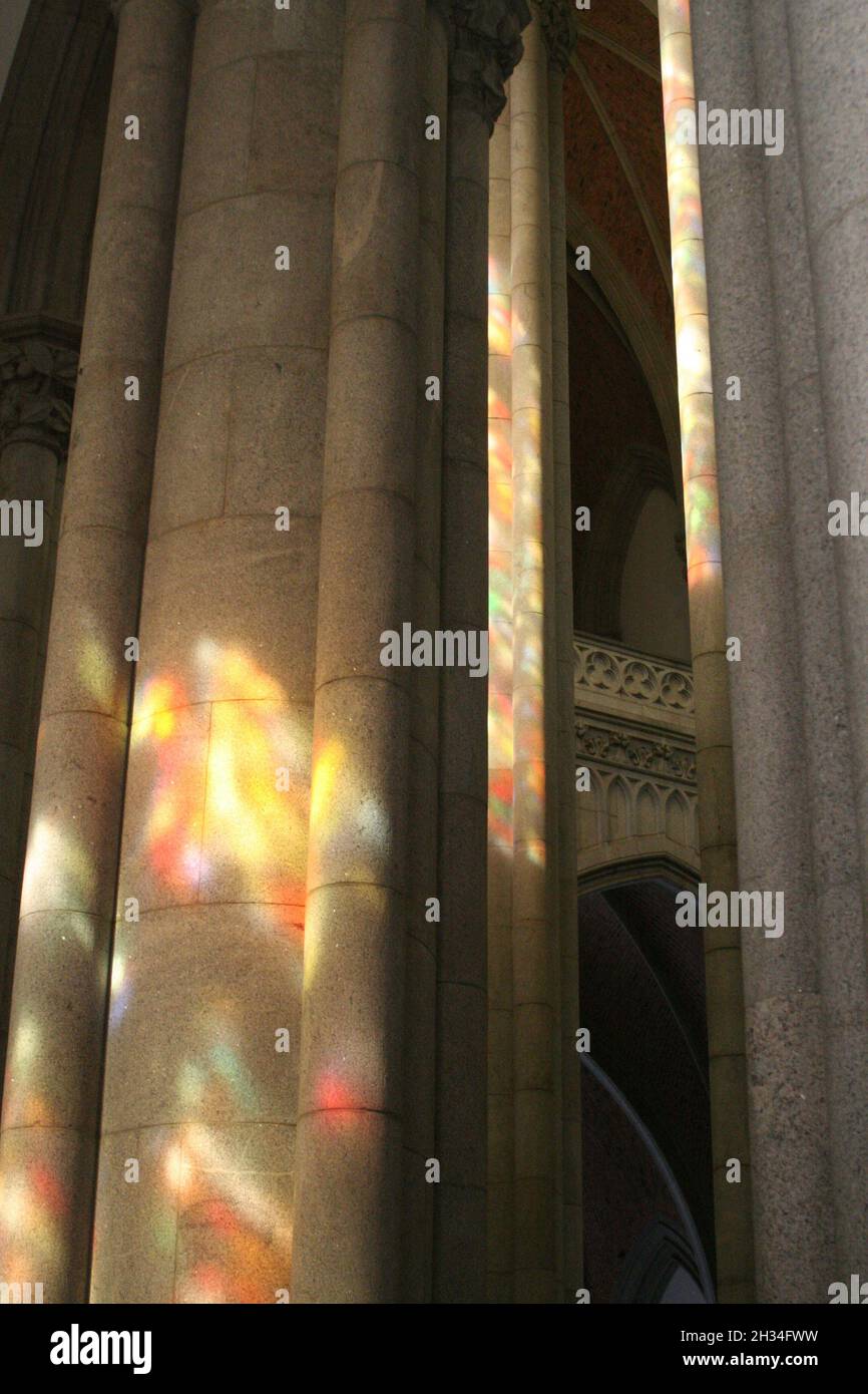 Sunlight refracted into colours by stained glass windows in a church ...