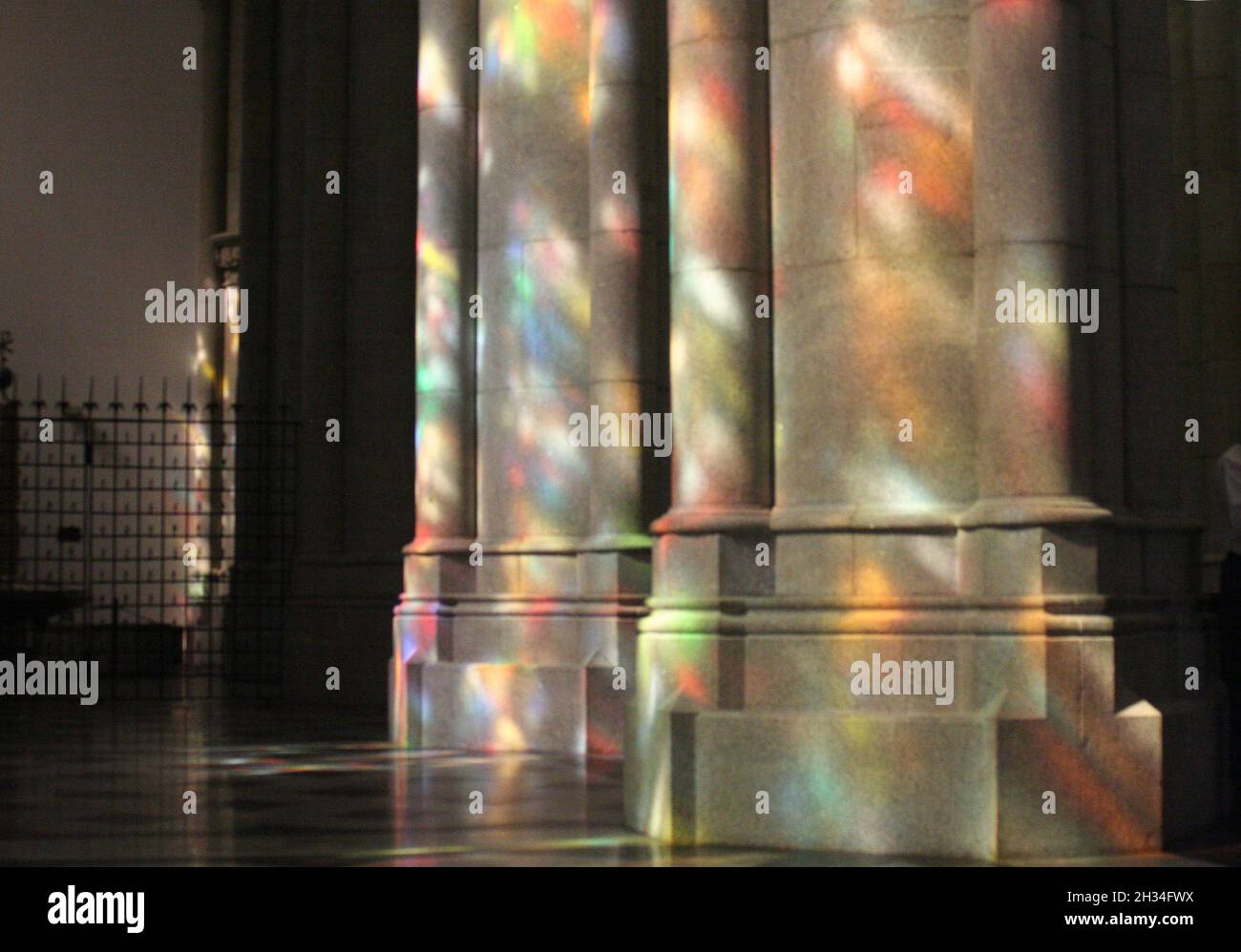 Sunlight refracted into colours by stained glass windows in a church ...