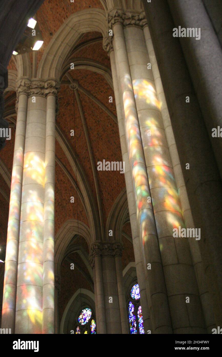 Sunlight refracted into colours by stained glass windows in a church ...