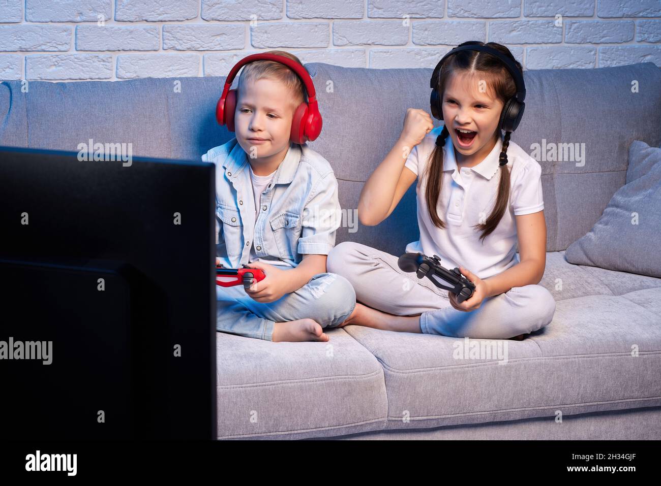 children playing video game with game console Stock Photo - Alamy