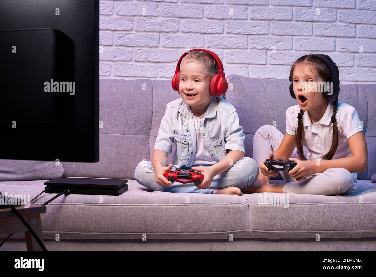 children playing video game with game console Stock Photo - Alamy