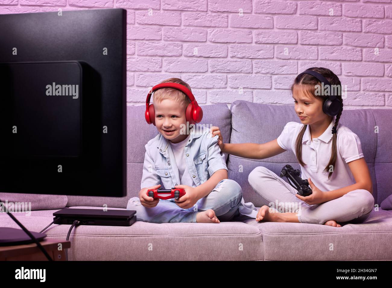 children playing video game with game console Stock Photo - Alamy