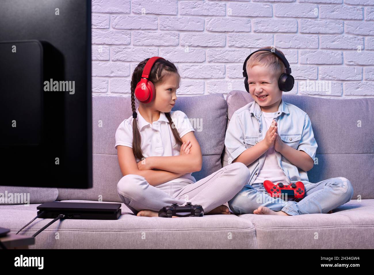 children playing video game with game console Stock Photo - Alamy