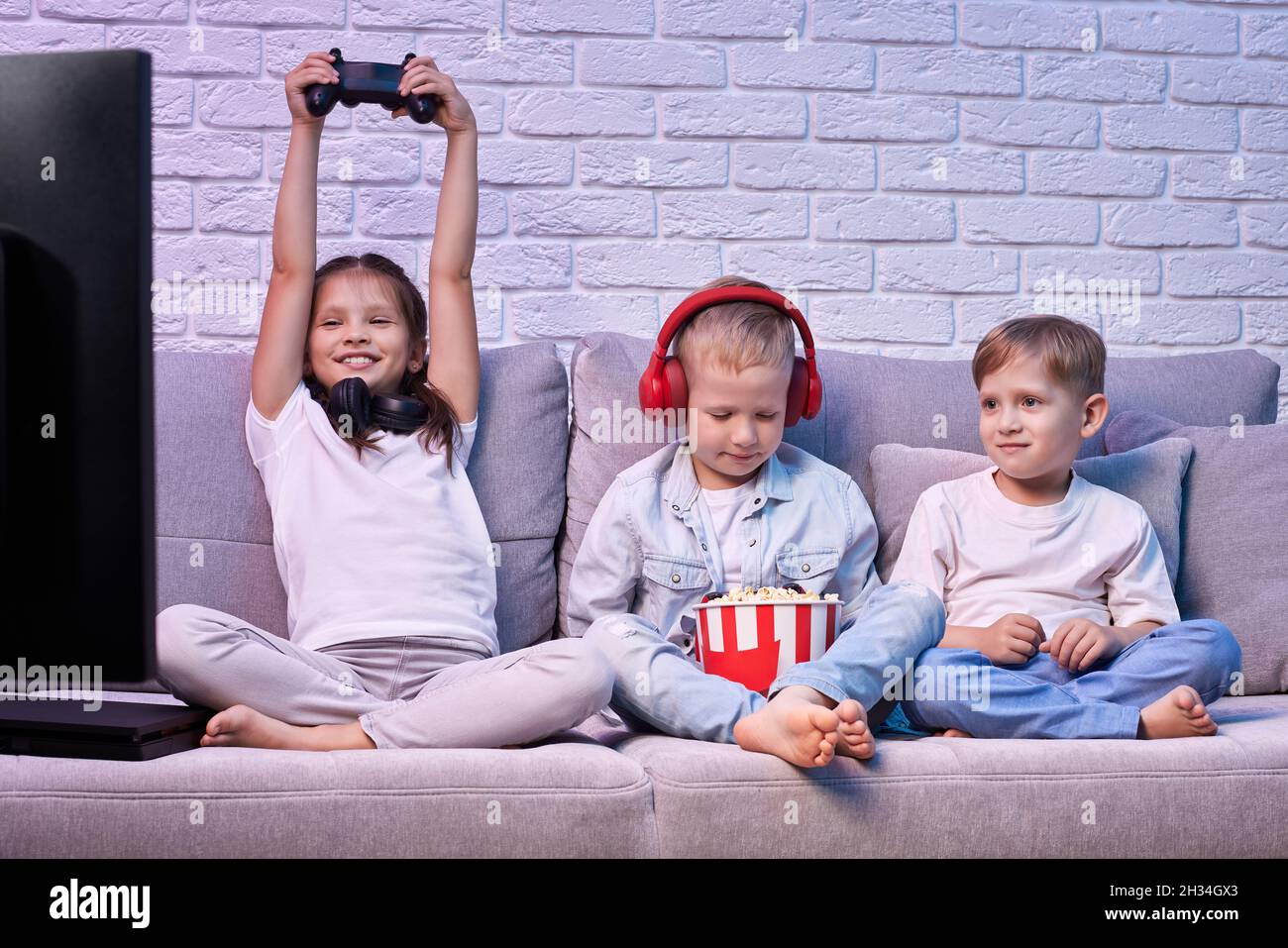 children playing video game with game console Stock Photo - Alamy