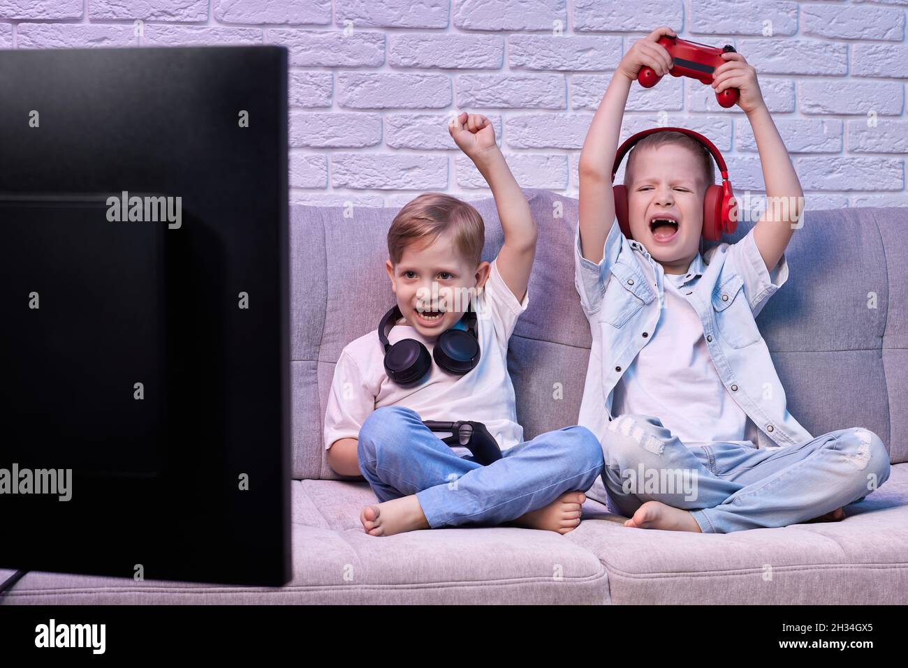 children playing video game with game console Stock Photo - Alamy