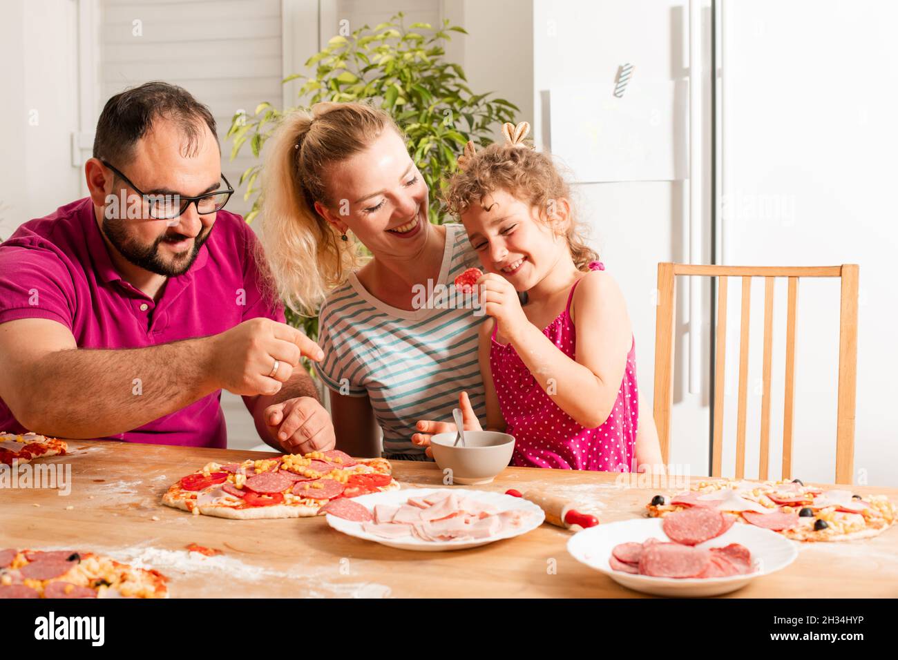 the happy young family are cooking homemade pizza Stock Photo - Alamy