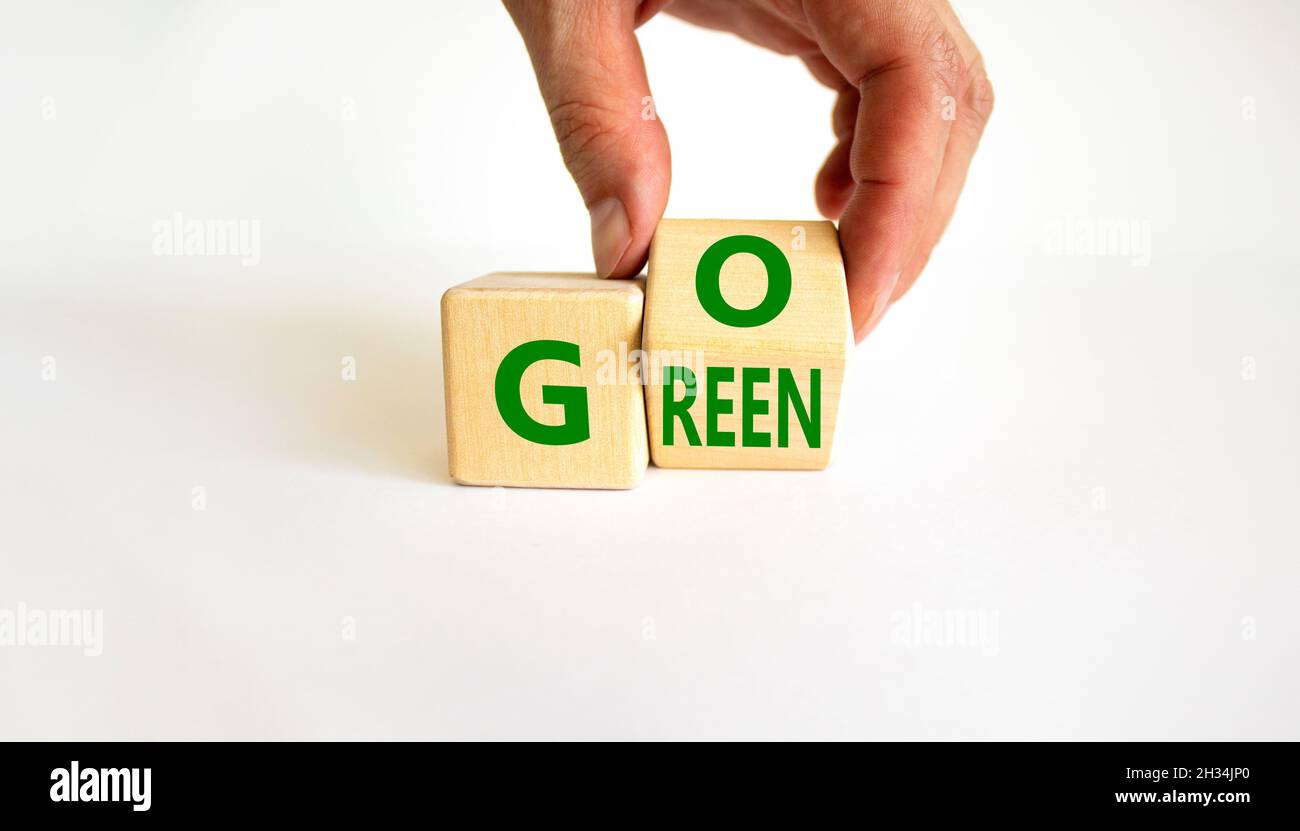 Ecology and go green symbol. Businessman turns a wooden cube with ...