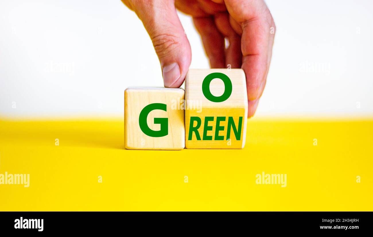Ecology and go green symbol. Businessman turns a wooden cube with ...