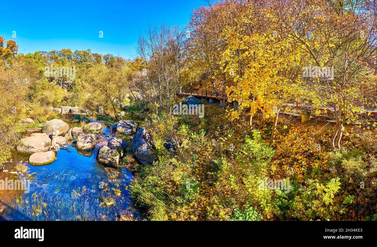 The scenic autumn Drevlians Park with golden trees and flowing among ...