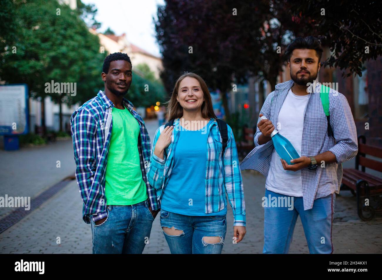 The multi-ethnic students with a bottle of non-alcoholic sparkling wine ...