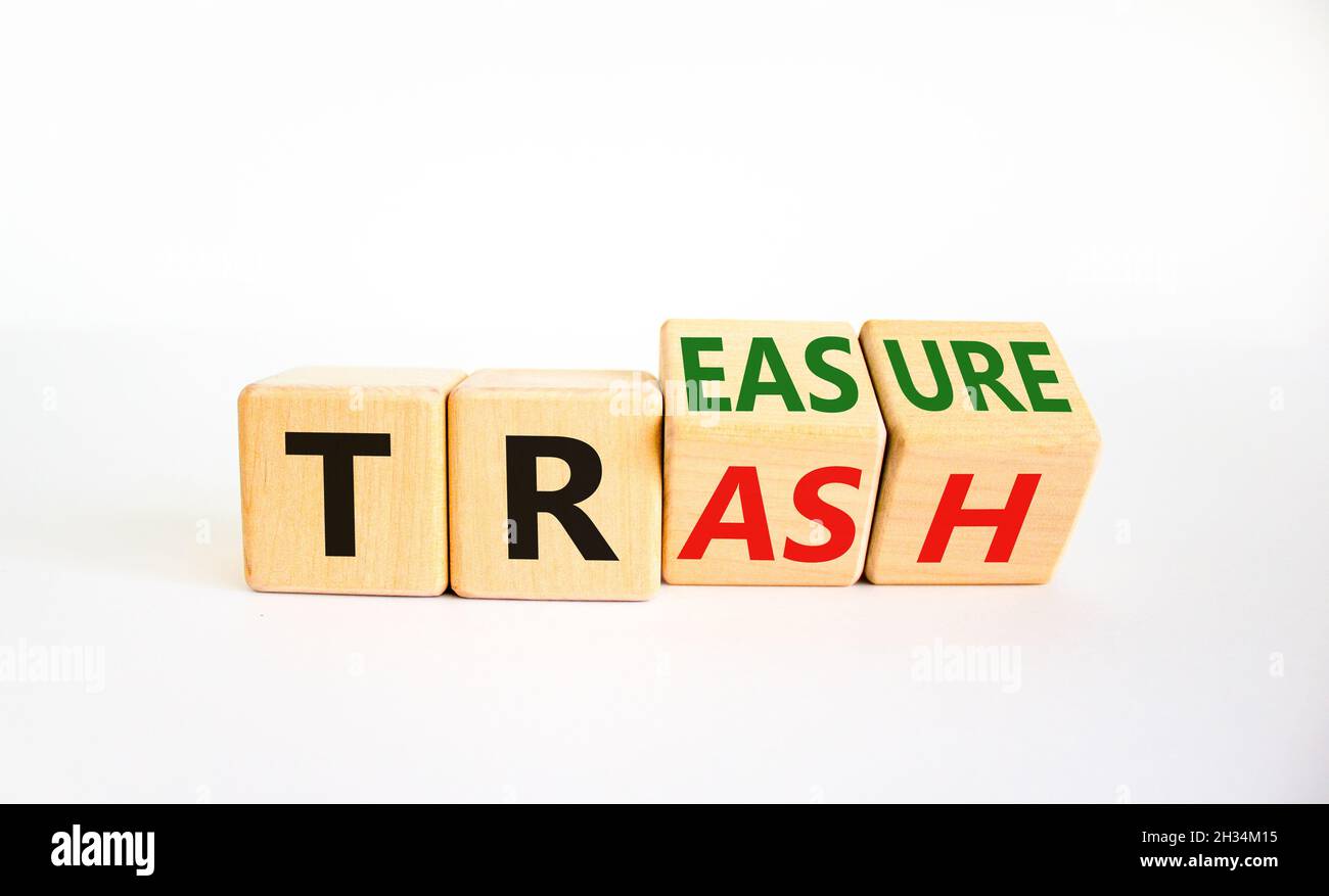 Trash to treasure symbol. Businessman turned cubes and changed the word ...