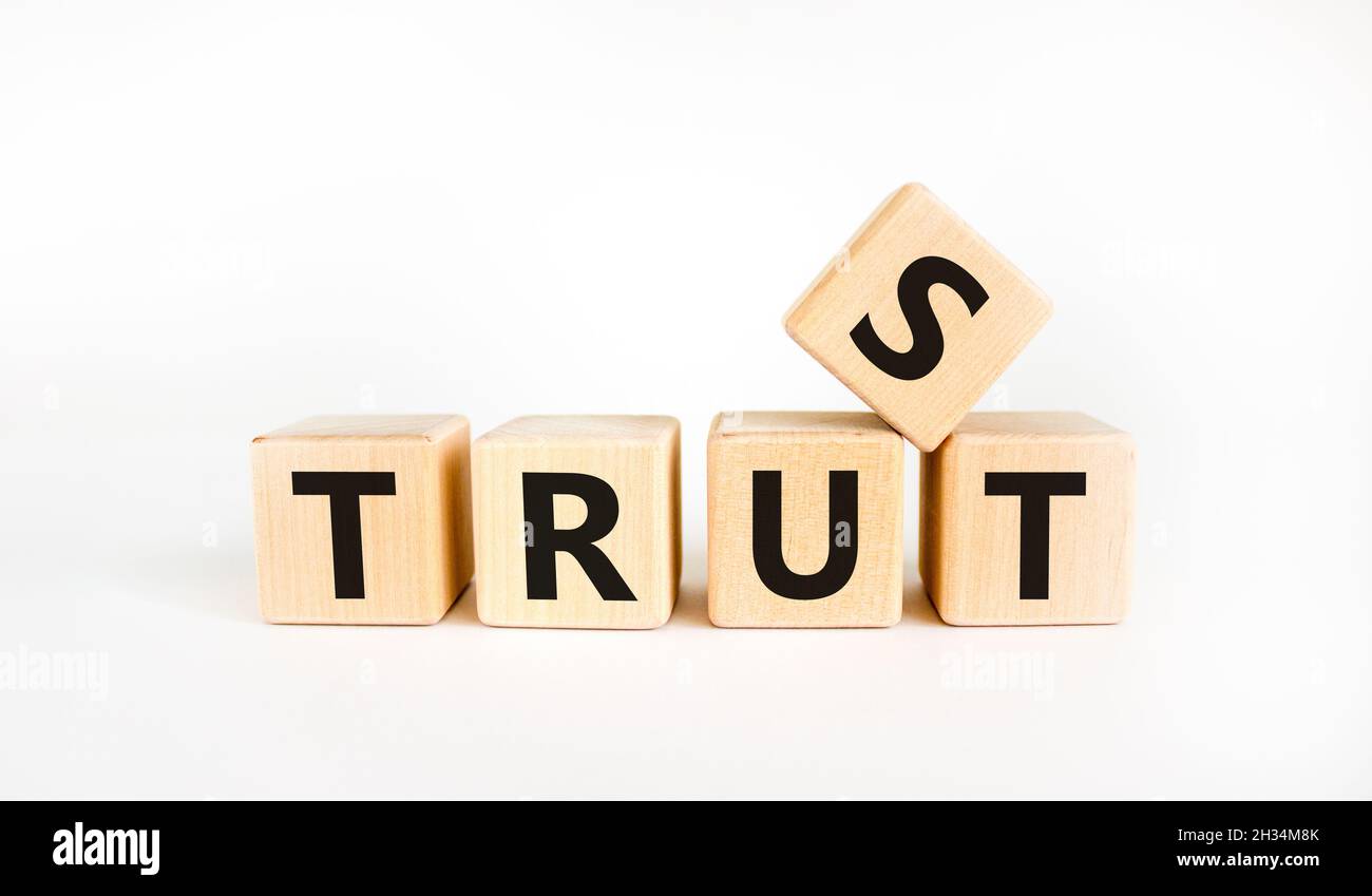 Trust symbol. The concept word 'trust' on wooden cubes. Beautiful white ...