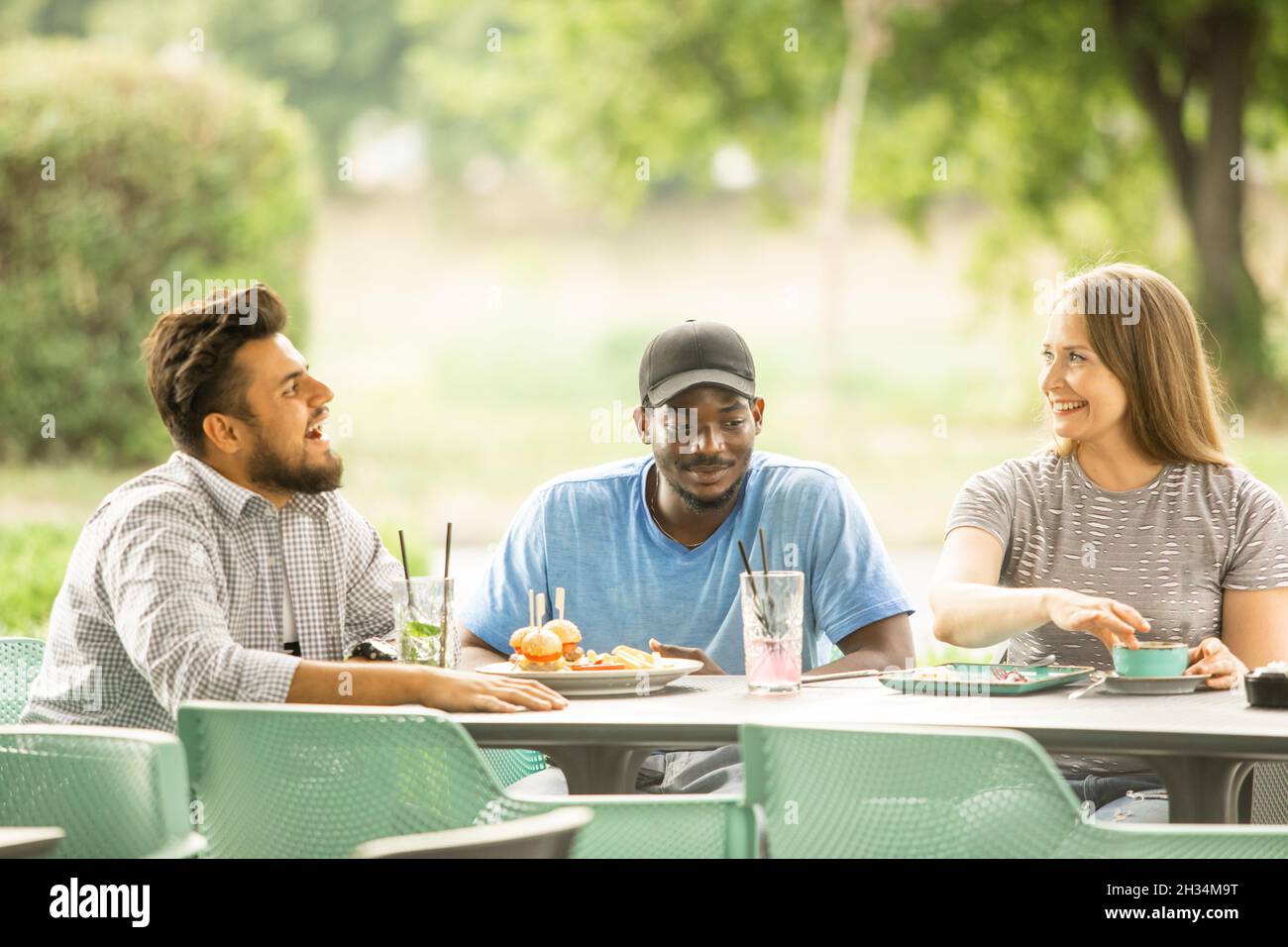 Group of young people meeting at a cafe Stock Photo - Alamy