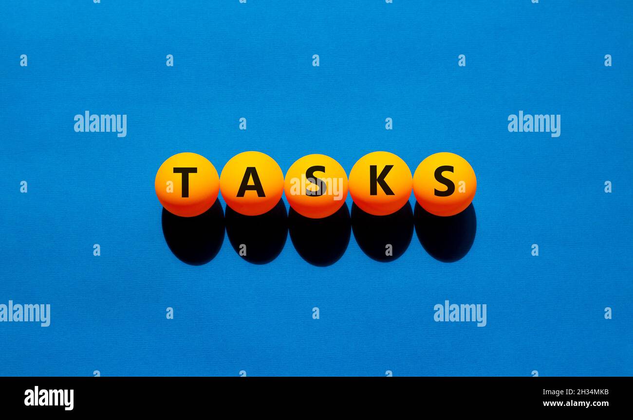Tasks symbol. The concept word 'tasks' on orange table tennis balls ...