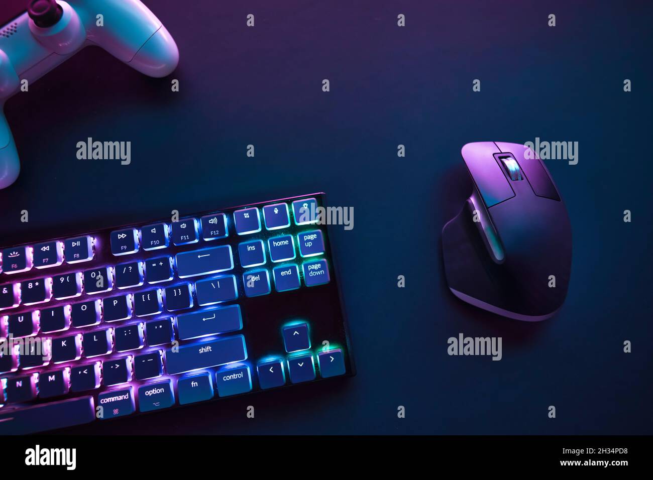 Top down view of color backlighted computer keyboard, mouse and game ...