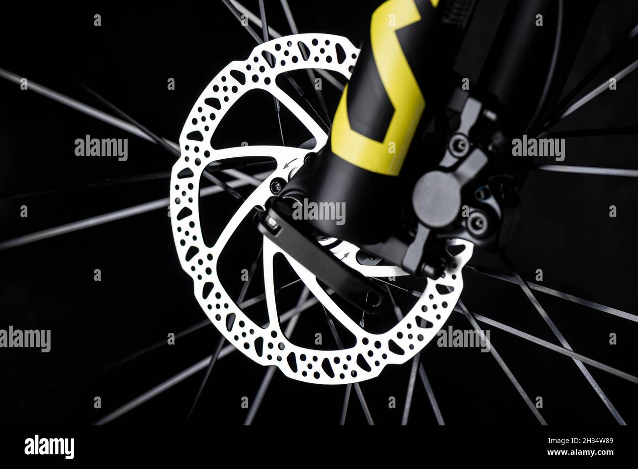 Closeup the disc break system on the moutain bike over black background ...