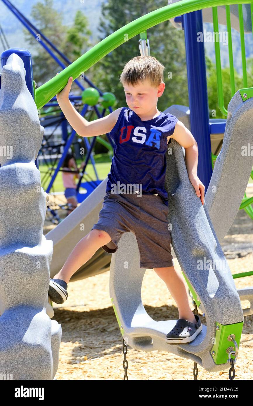 BOY AT A PLAYGROUND Stock Photo - Alamy