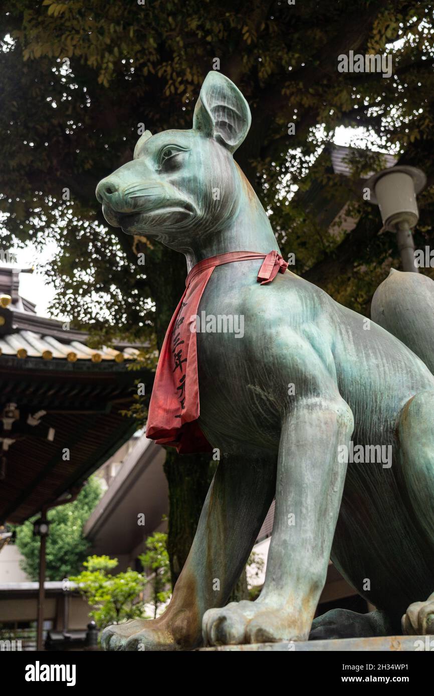 A massive bronze statue of Inari Kitsune or fox goddess, guard the ...